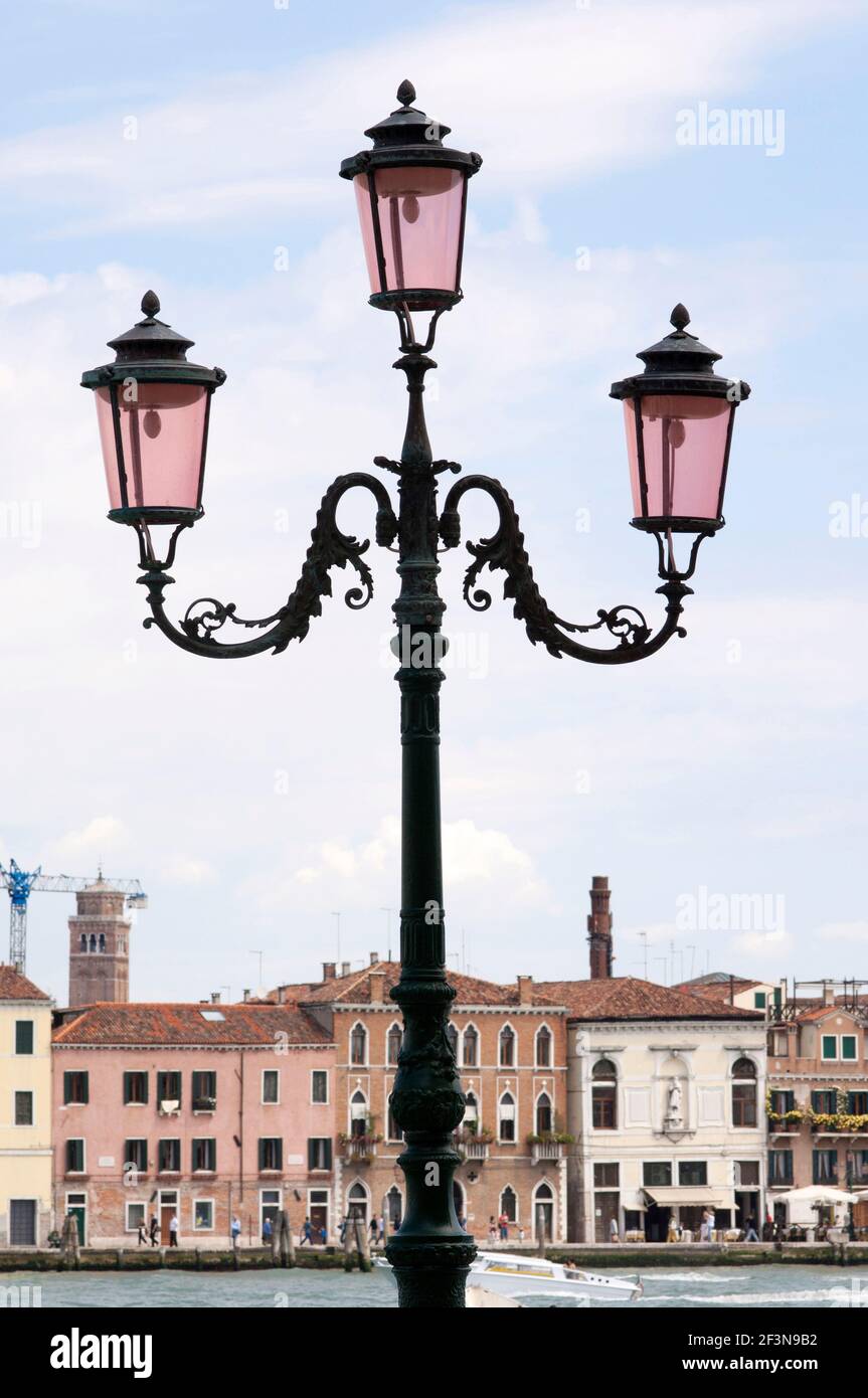 Ornate lamp post alongside the canal La Giudecca in the historic city ...