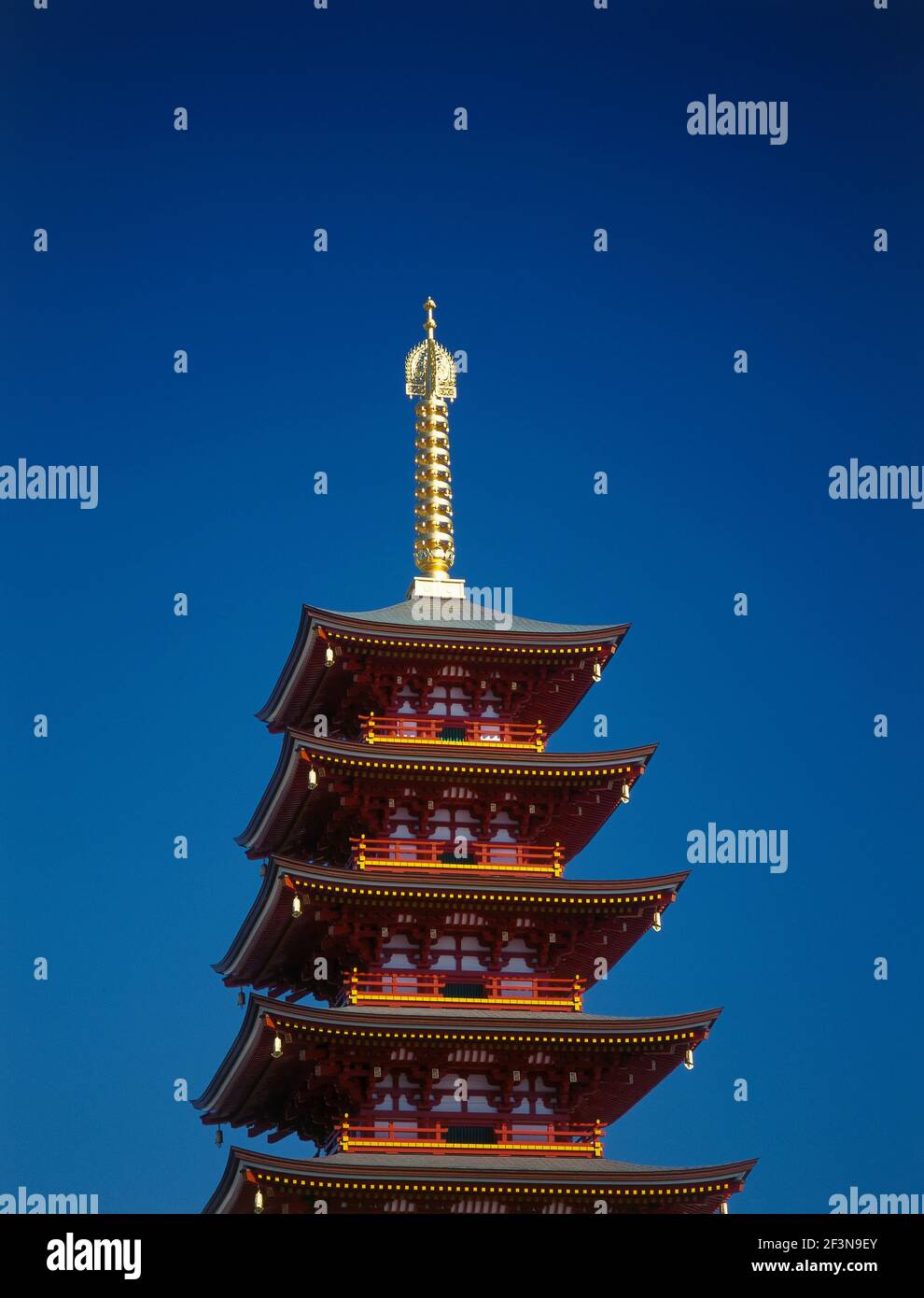 Japanese pagoda. Ornate roof painted red and yellow. Gold detail on top ...