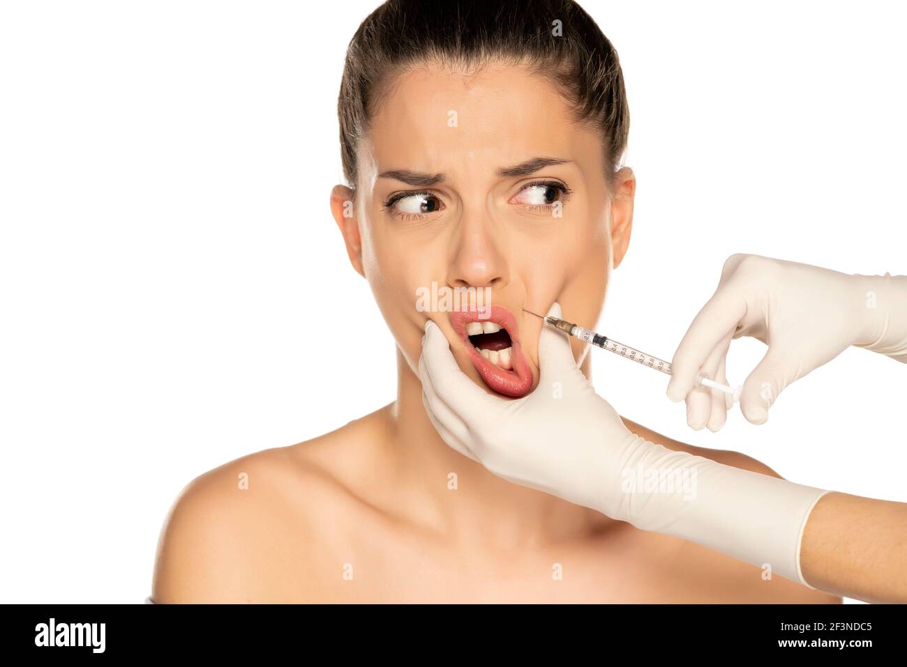 Portrait of a young frightened woman on a face filler injection ...