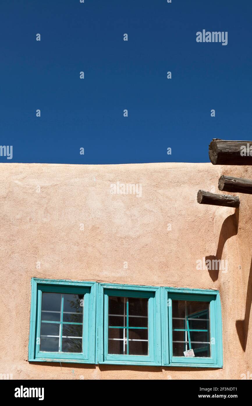 Three windows on an adobe house in Taos, New Mexico, USA Stock Photo ...