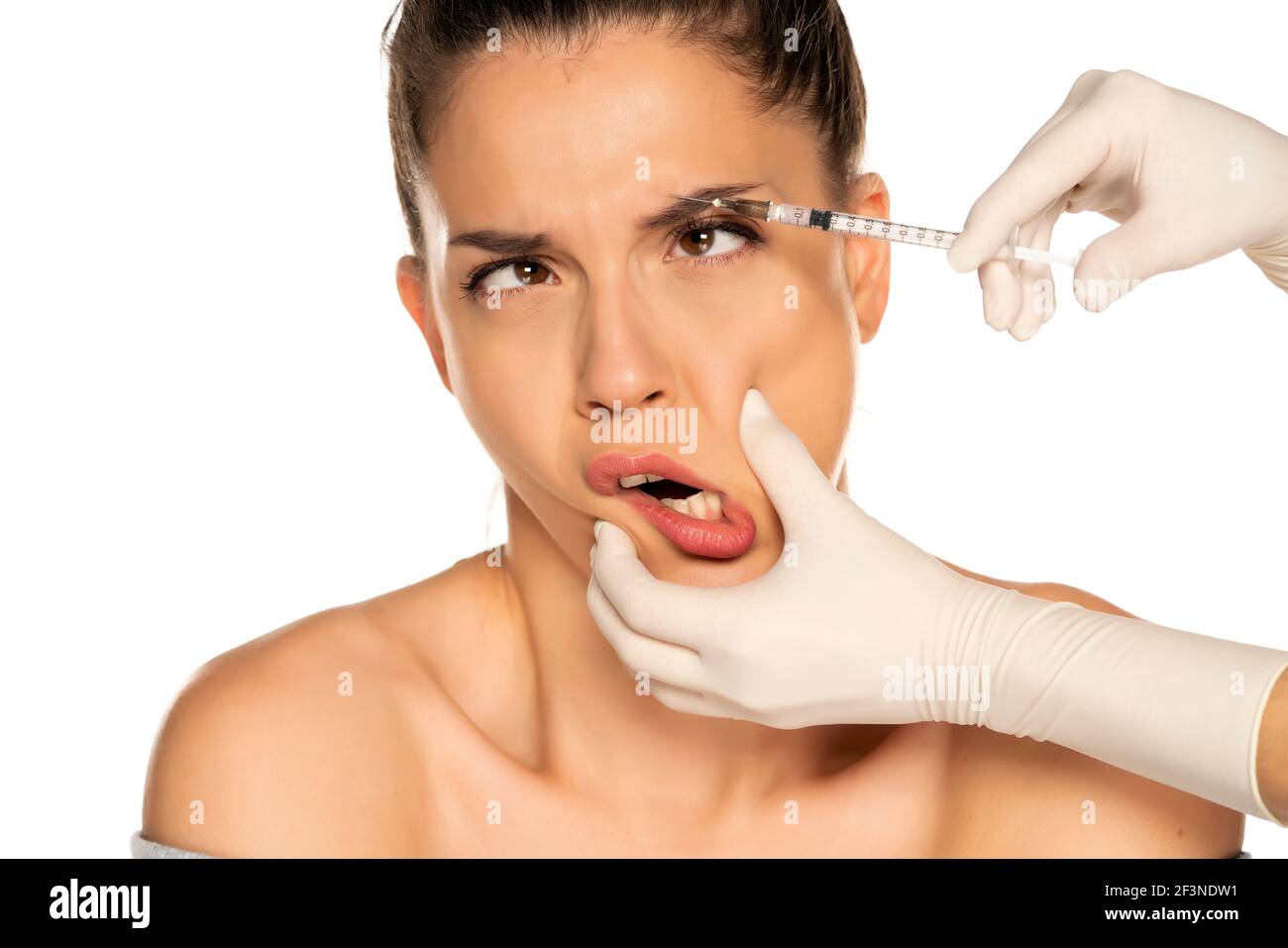 Portrait of a young frightened woman on a face filler injection ...