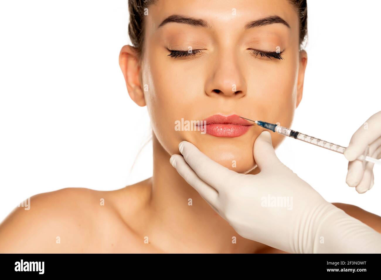 Portrait of a young beautiful woman on a botox injection procedure on ...