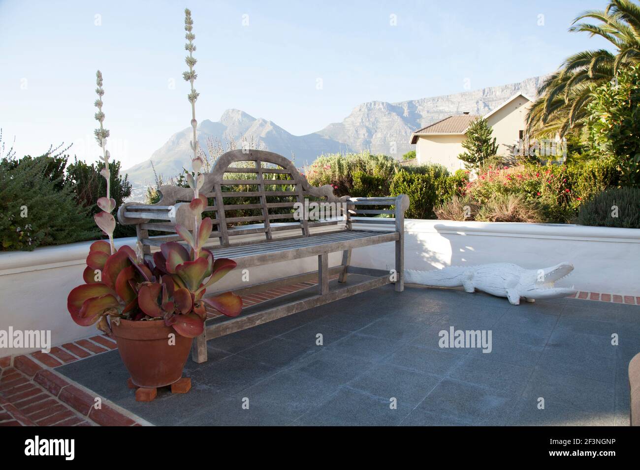 Balinese wooden bench on patio with views of Table Mountain Stock Photo ...