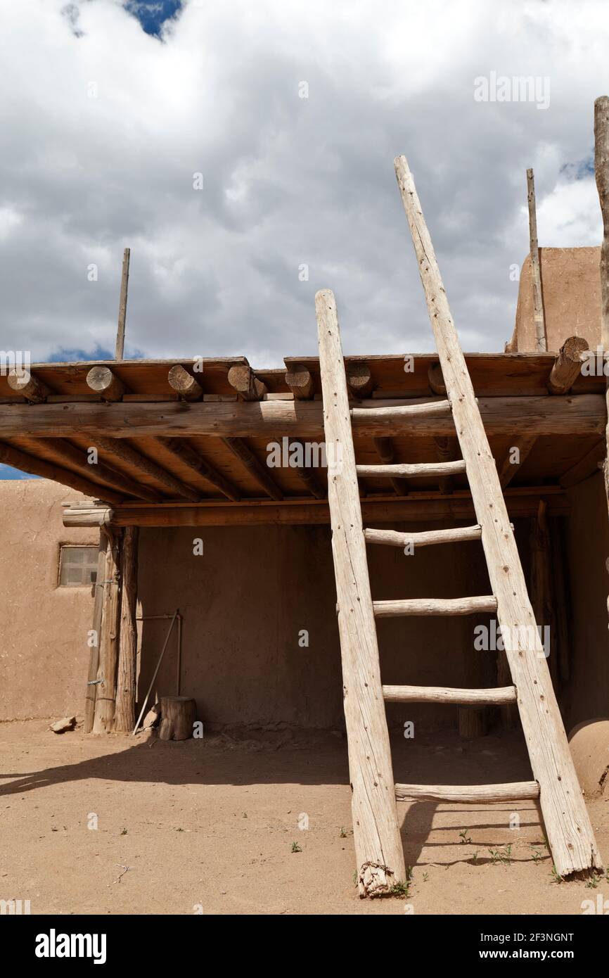 A Pueblo ladder outside a storeroom in Taos Pueblo, New Mexico, USA ...