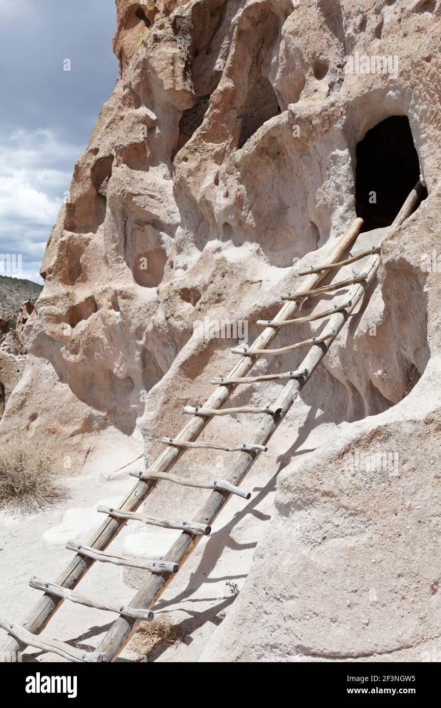 A pueblo ladder leads up to a cliff dwelling in Bandelier National ...