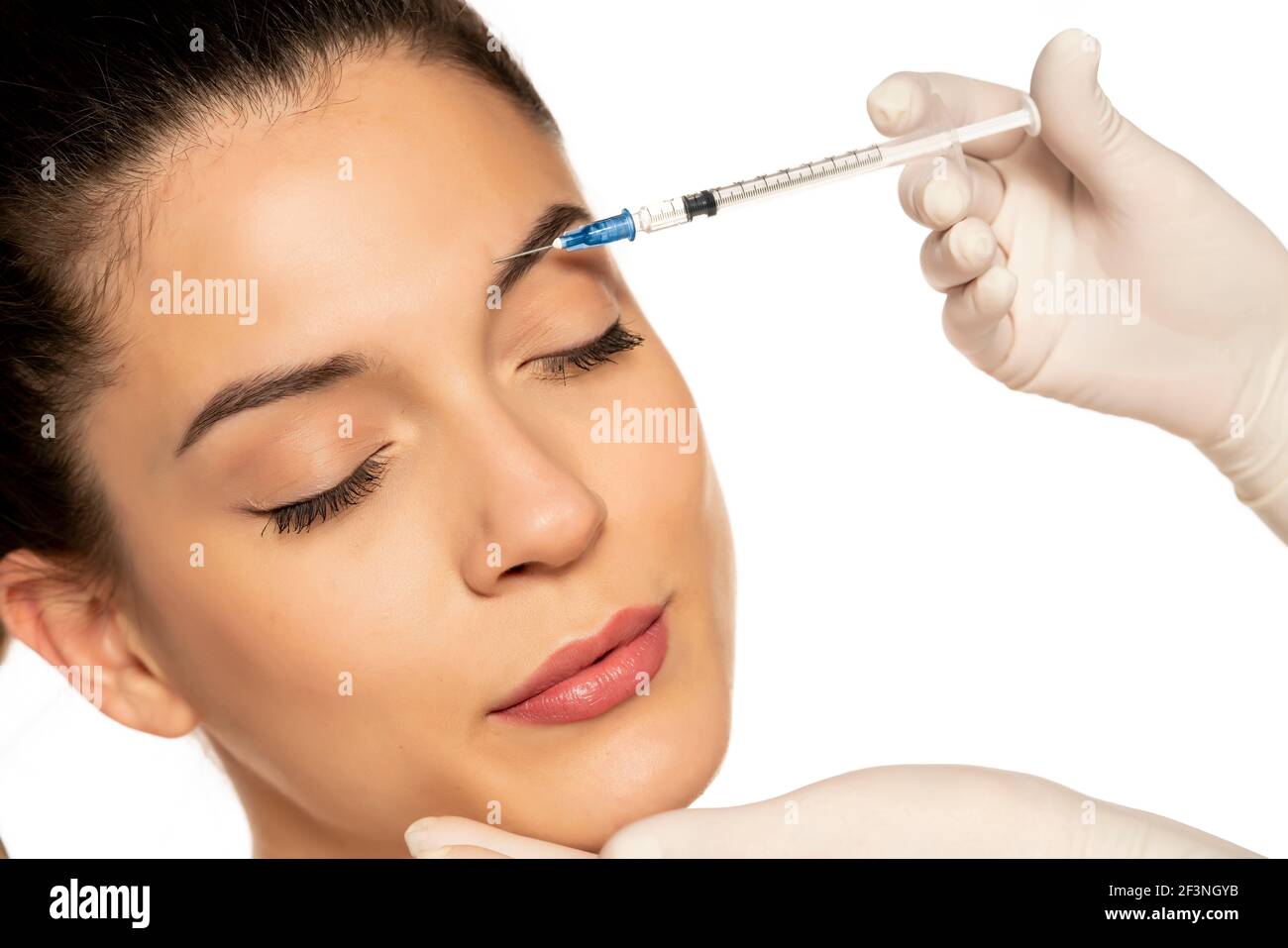 Portrait of a young beautiful woman on a filler injection procedure on ...