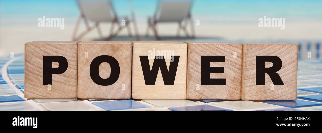 POWER message word on a wooden cube blocks with a ocean beach ...