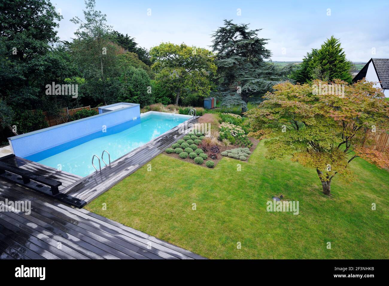Exterior looking down on the garden and swimming pool from the covered ...