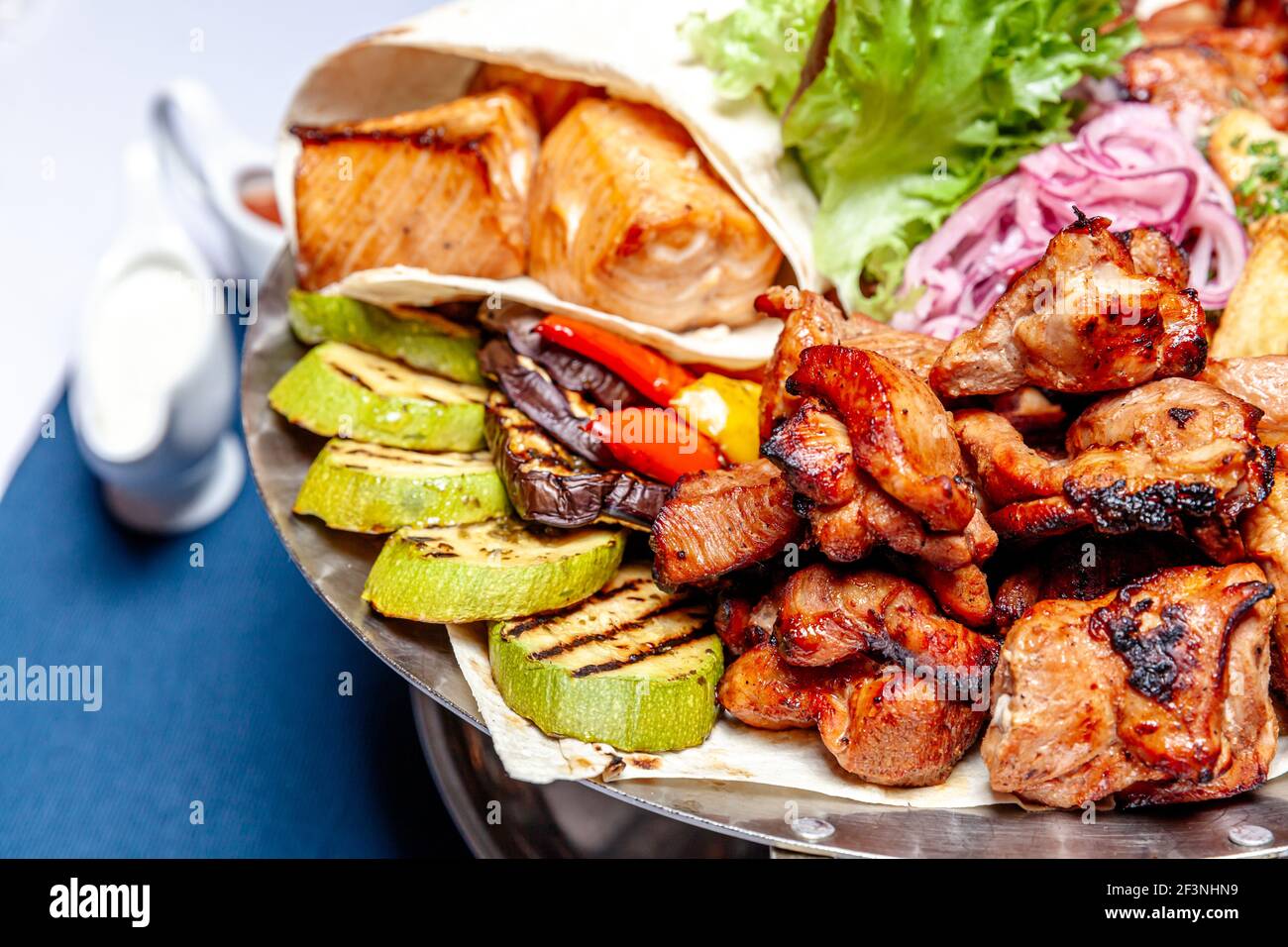 Mixed grill meat fried vegetables and grilled salmon fish fillets ...