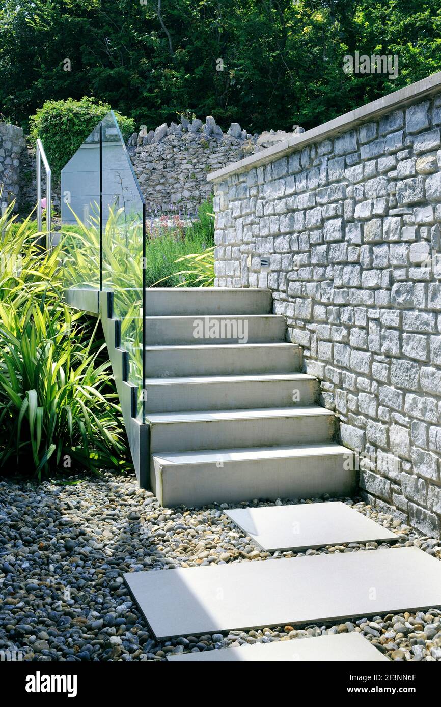 A low profile building in a seaside location. Steps to a terrace with a ...