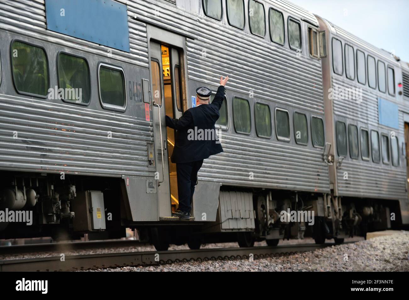 Lombard, Illinois, USA. A conductor waves an all clear for a departure ...