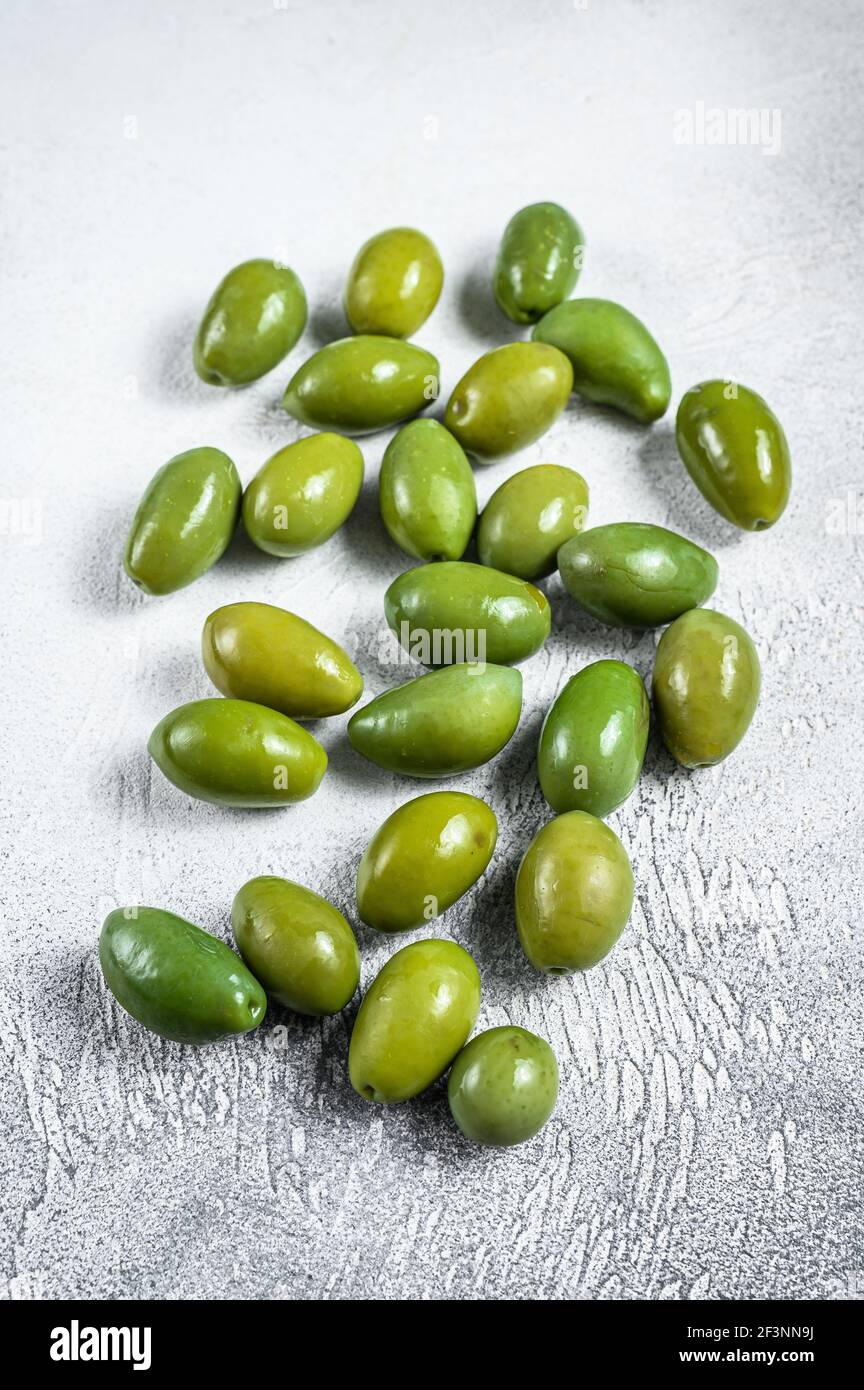 Fresh Green big olives on a table. White background. Top view Stock ...