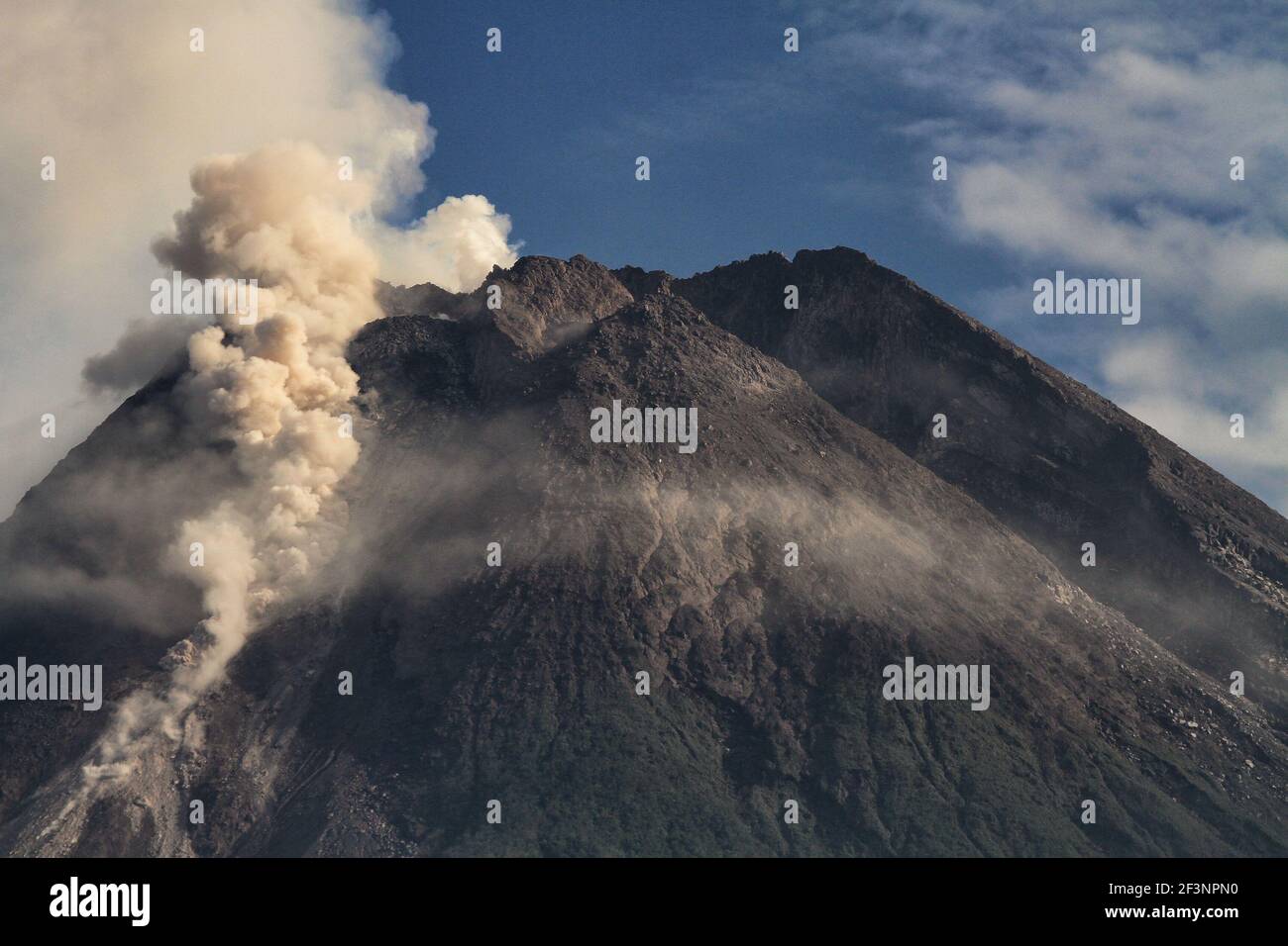 Indonesia most active volcano Mt. Merapi spews hot clouds Stock Photo ...