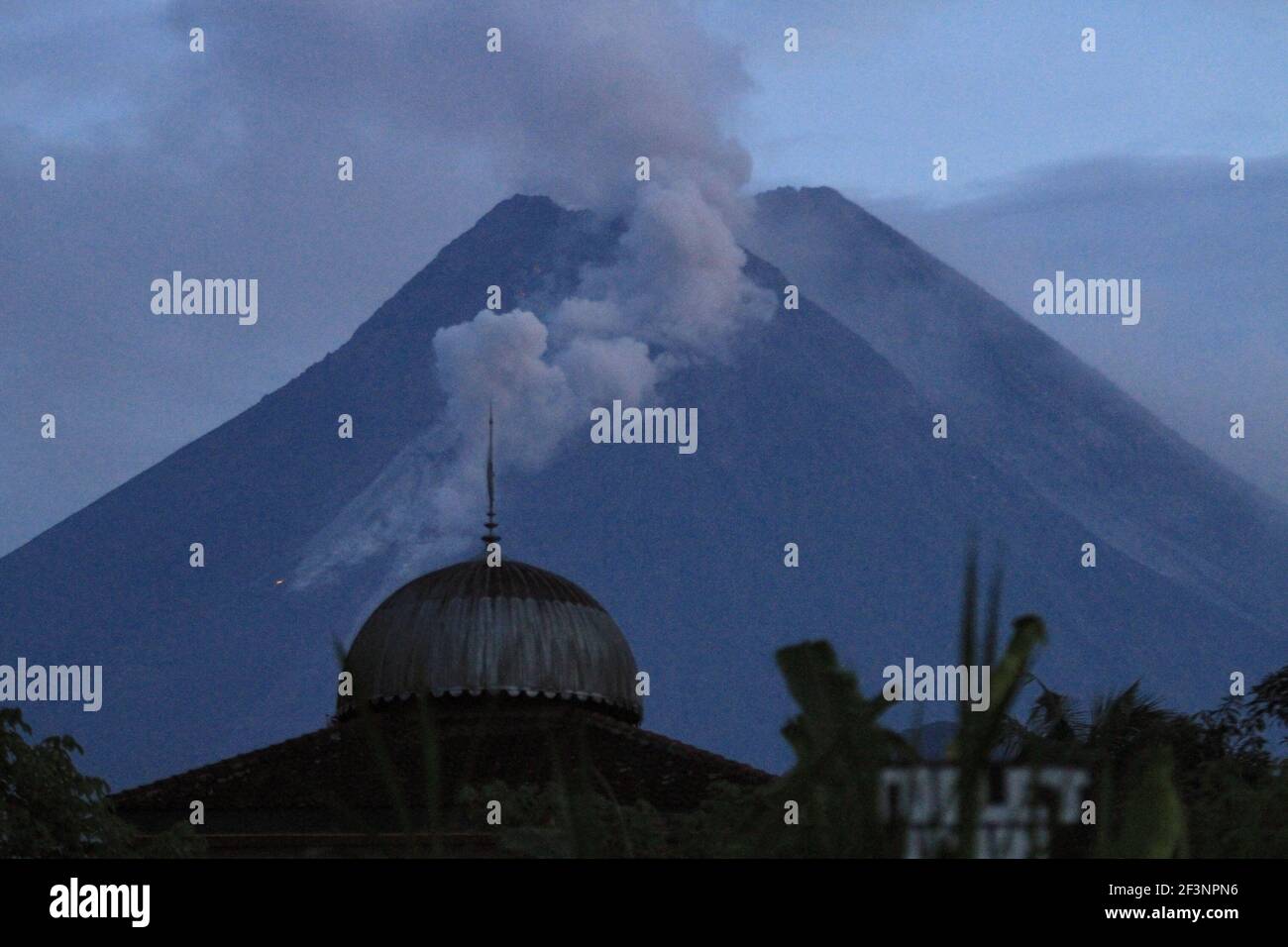 Indonesia most active volcano Mt. Merapi spews hot clouds Stock Photo ...