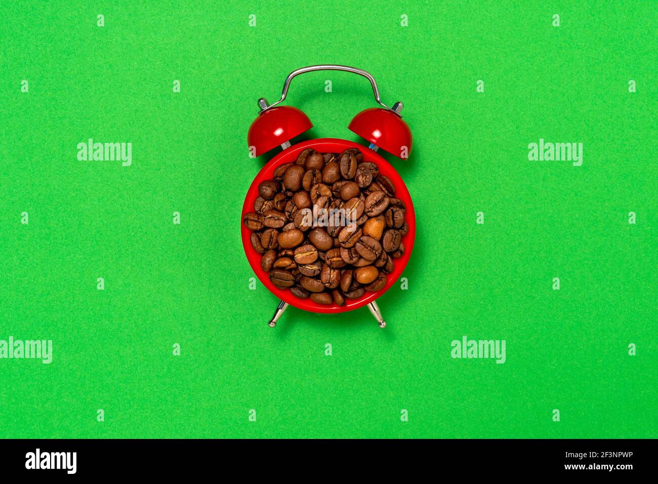 Morning coffee and alarm clock concept. Coffee beans on the clock face ...
