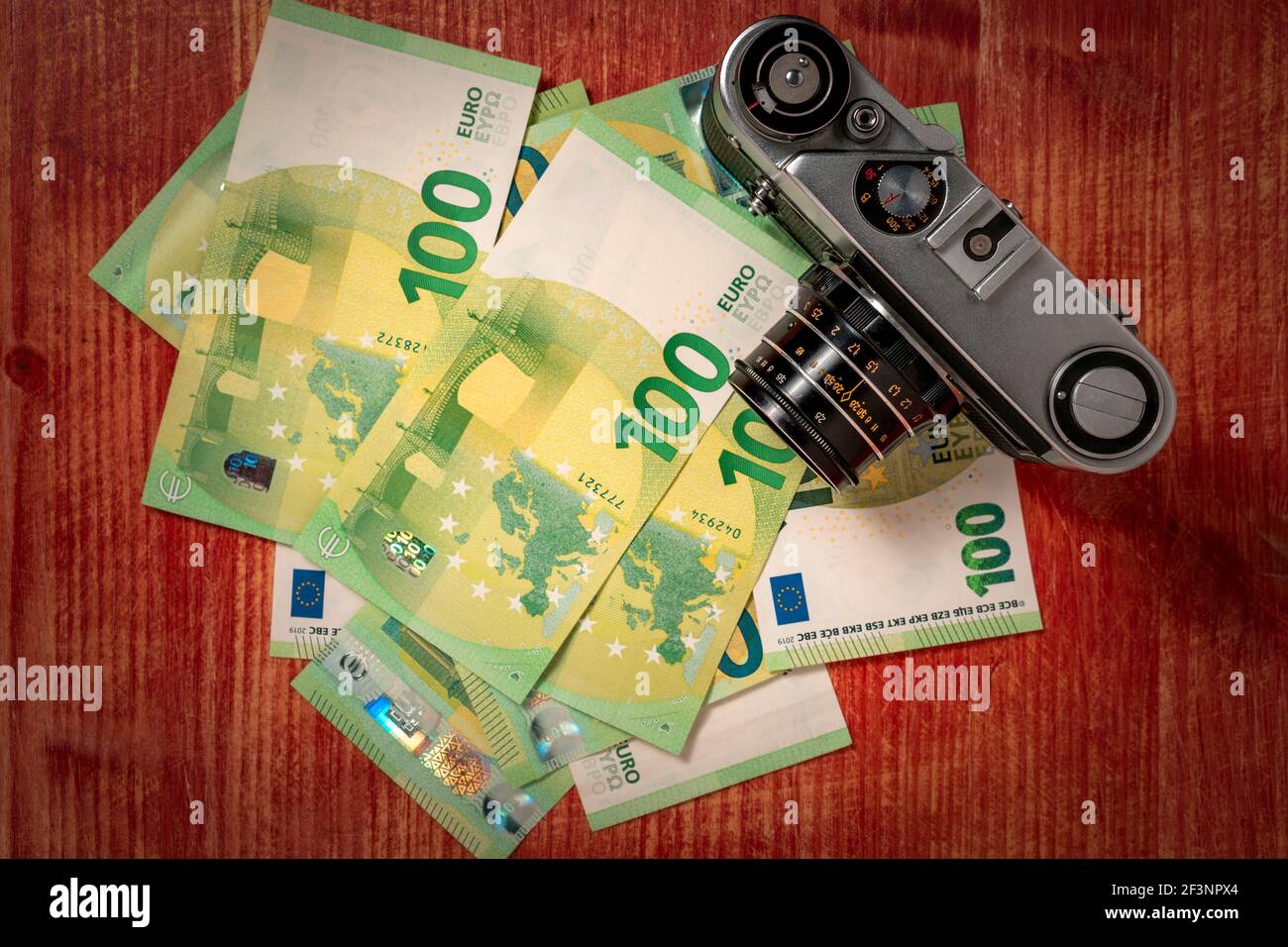 Making money on photography. Photographer's income. Old film camera and ...