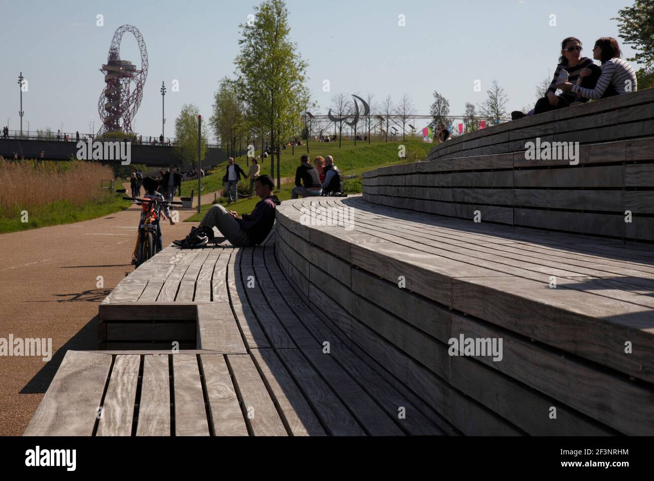 Stepped, curved timber deck seating with orbit tower beyond | Architect ...