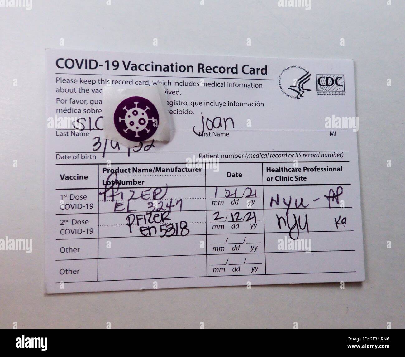Patient Covid 19 vaccinated record card and sticker Stock Photo - Alamy