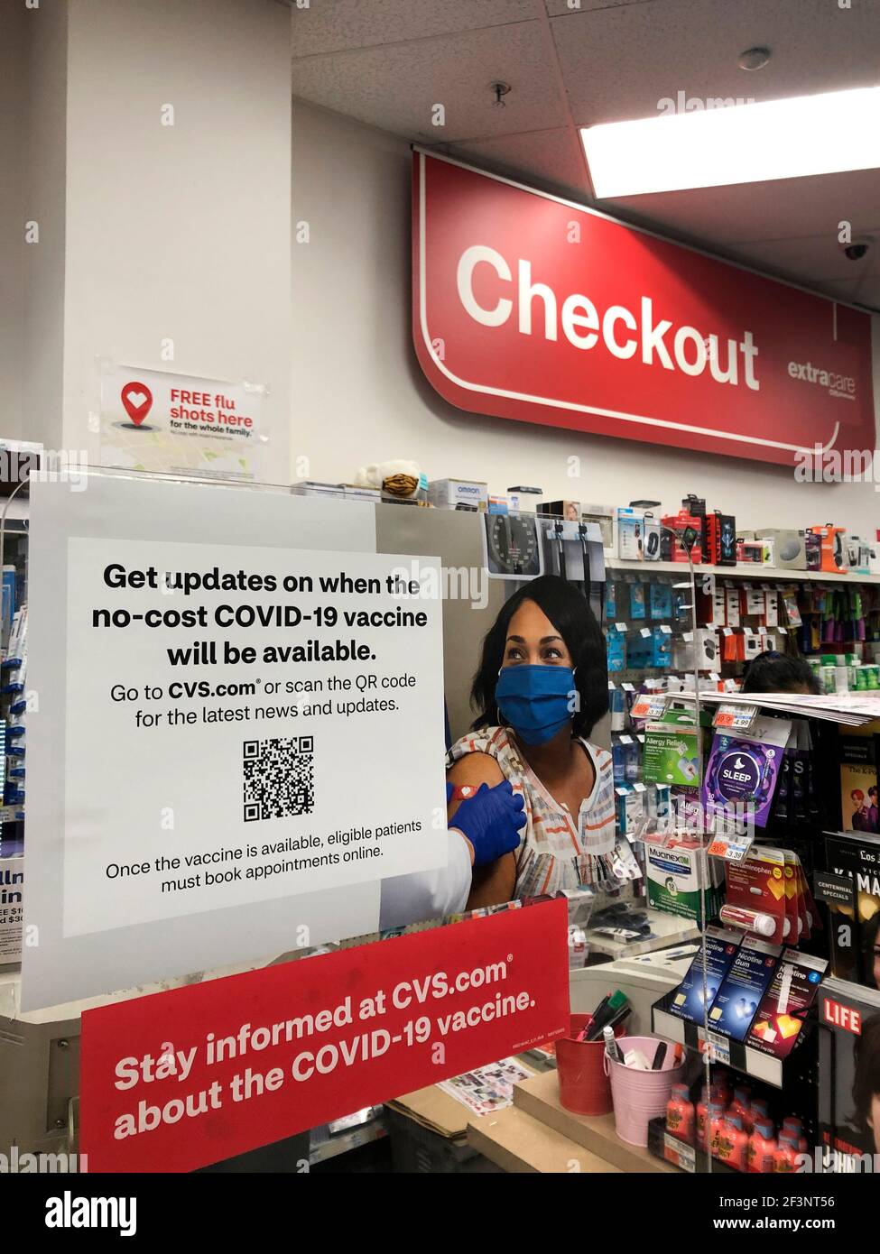 Covid-19 Vaccination update sign at CVS drugstore checkout counter ...