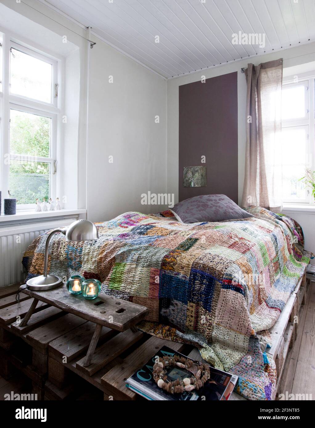 Ecology and Soft Colours. A bedroom and bedcovering, a large patchwork ...