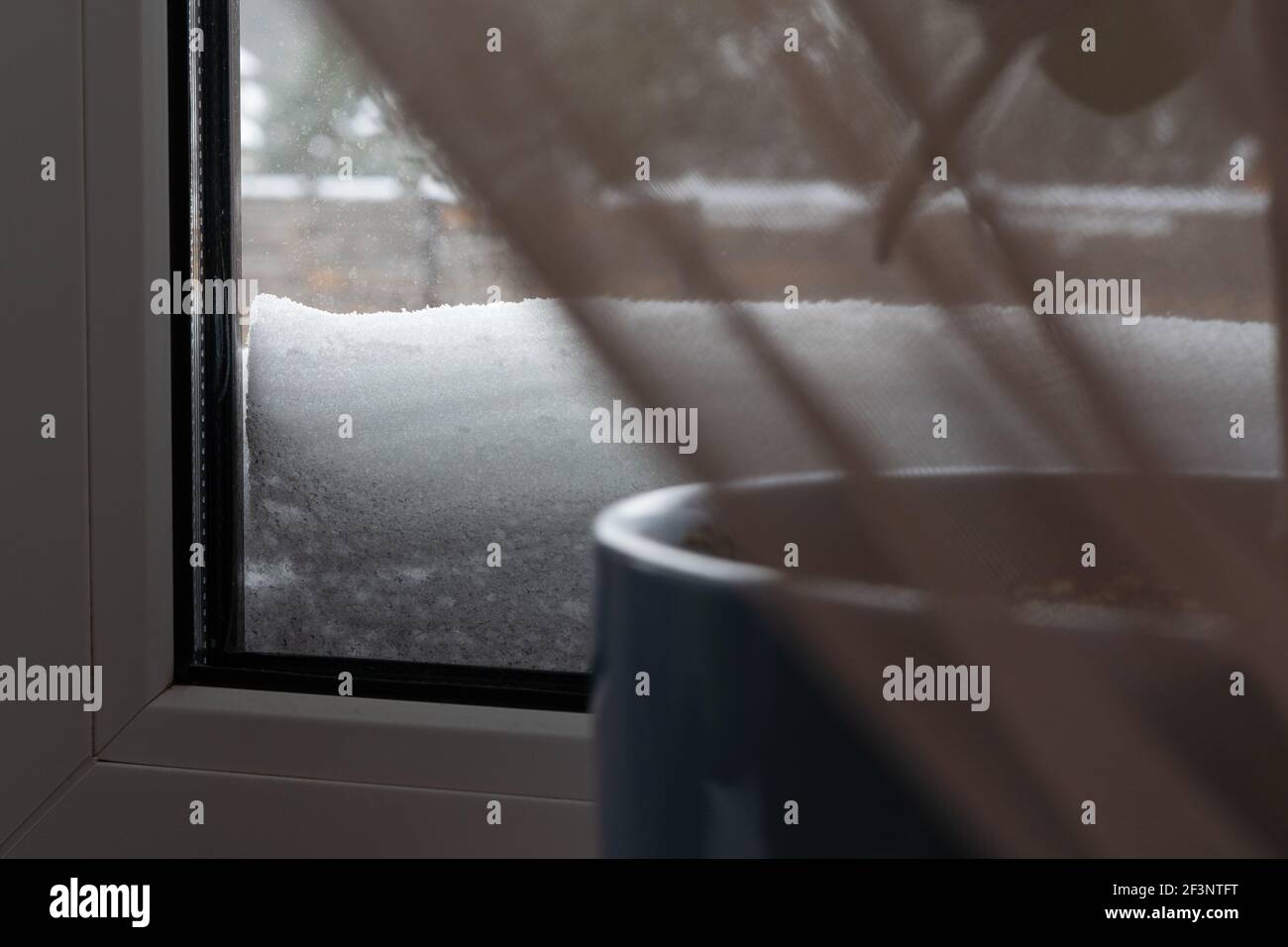 The window of the house was covered with snow, view from the interior ...