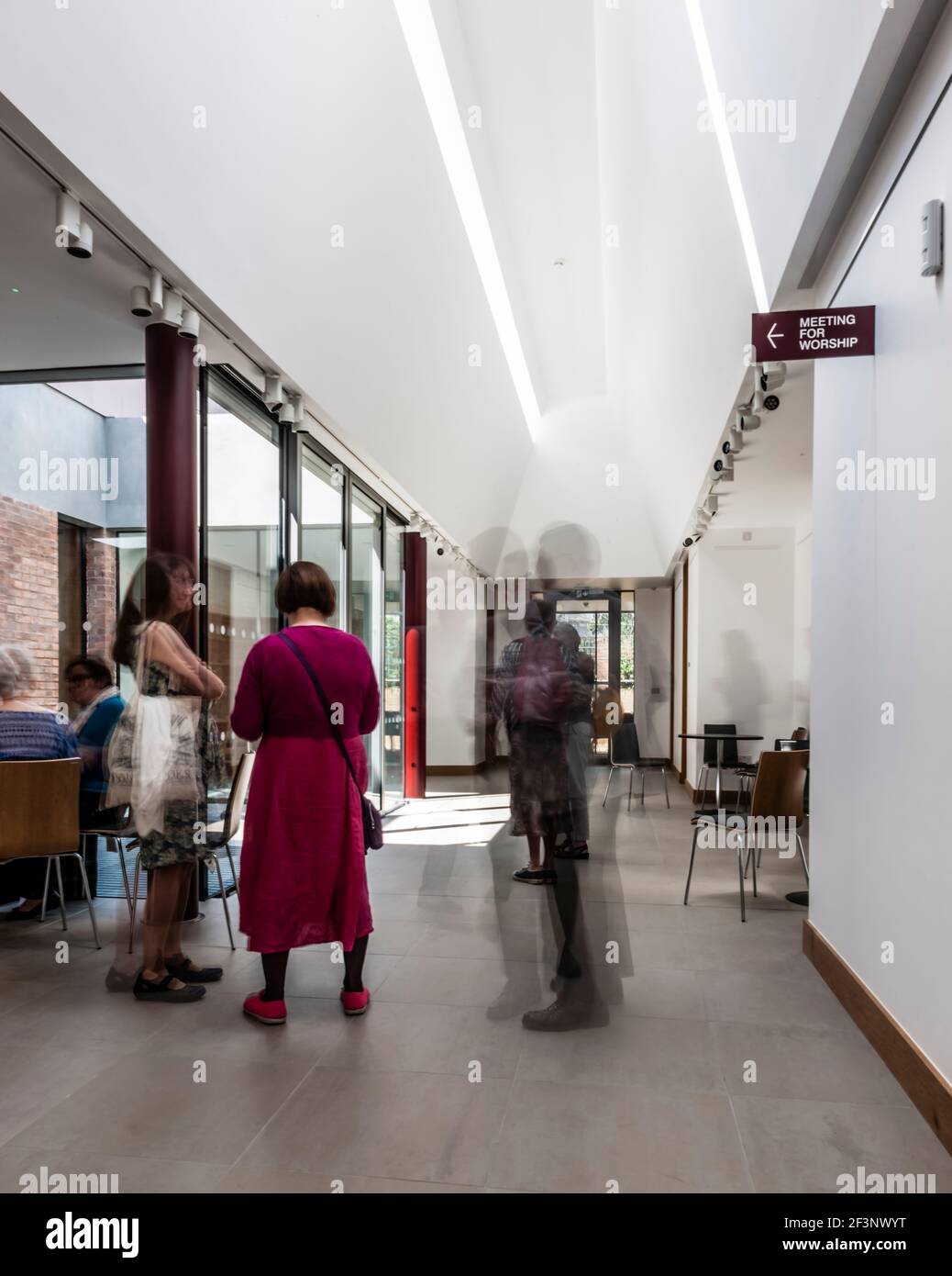 Atrium at the Kingston Quaker Centre, with people chatting Stock Photo ...