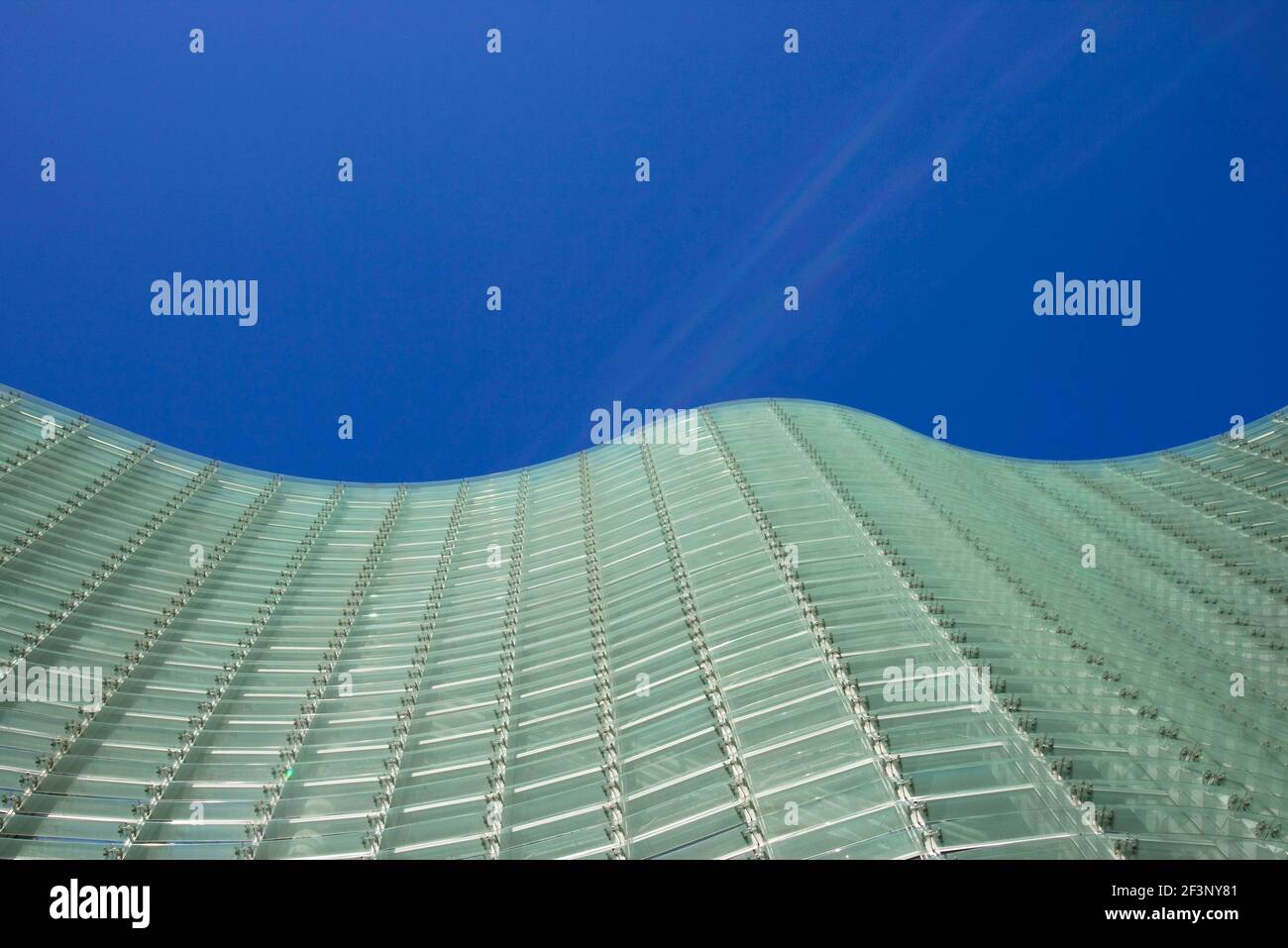 Exterior architectural curves undulate against a blue sky at the ...