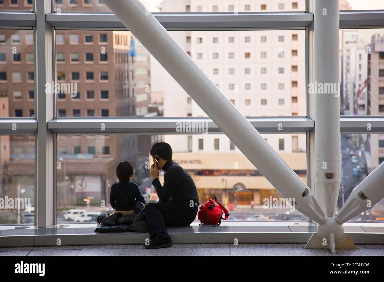 A detailed interior view shows a Japanese man and his young son ...