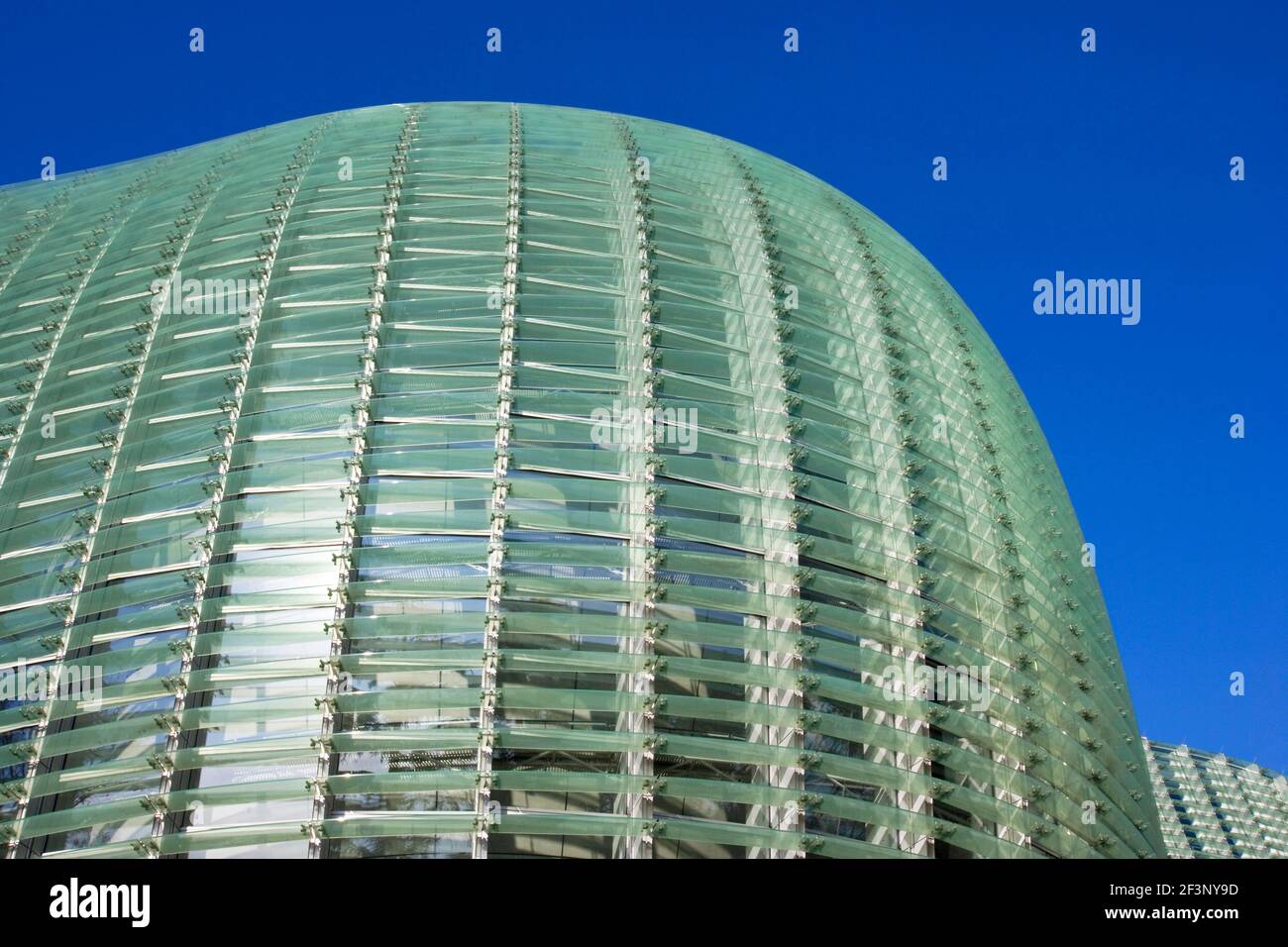 Exterior architectural curves arch across a clear blue sky at the ...