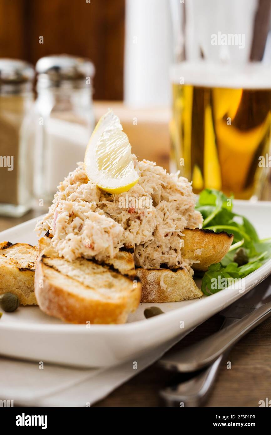 Flaked fish recipe on toasted ciabatta. Food ordered in pub Stock Photo ...