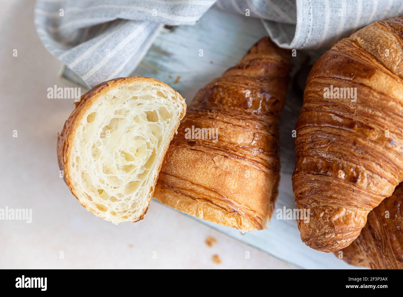Cut in half croissant with inside texture and thin crisp layers on ...