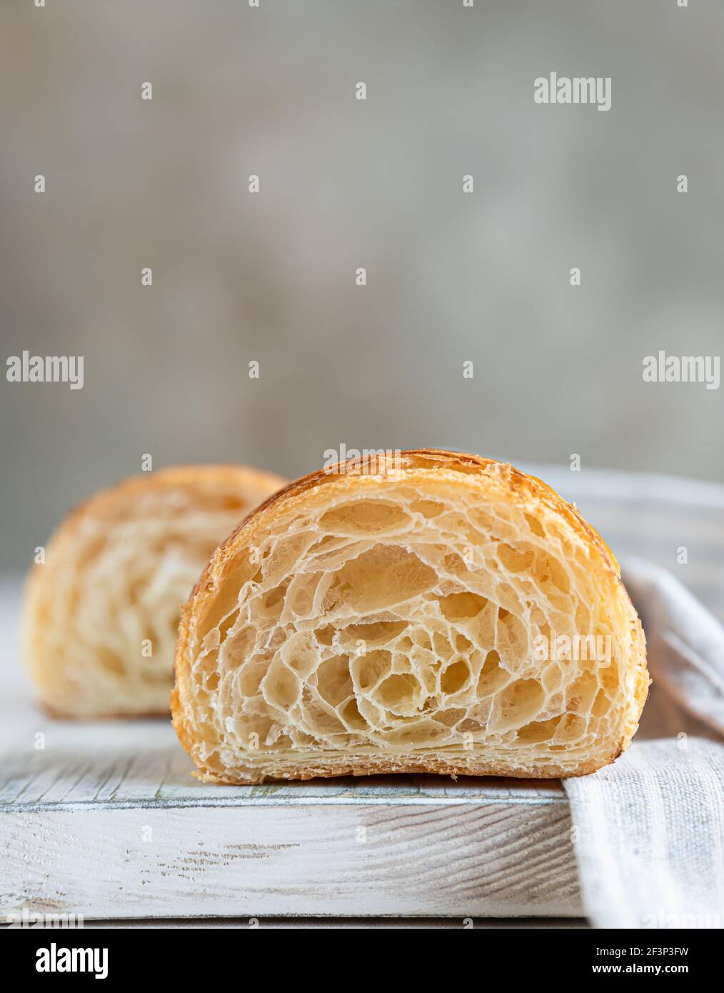 Cut in half croissant with inside texture and thin crisp layers on ...