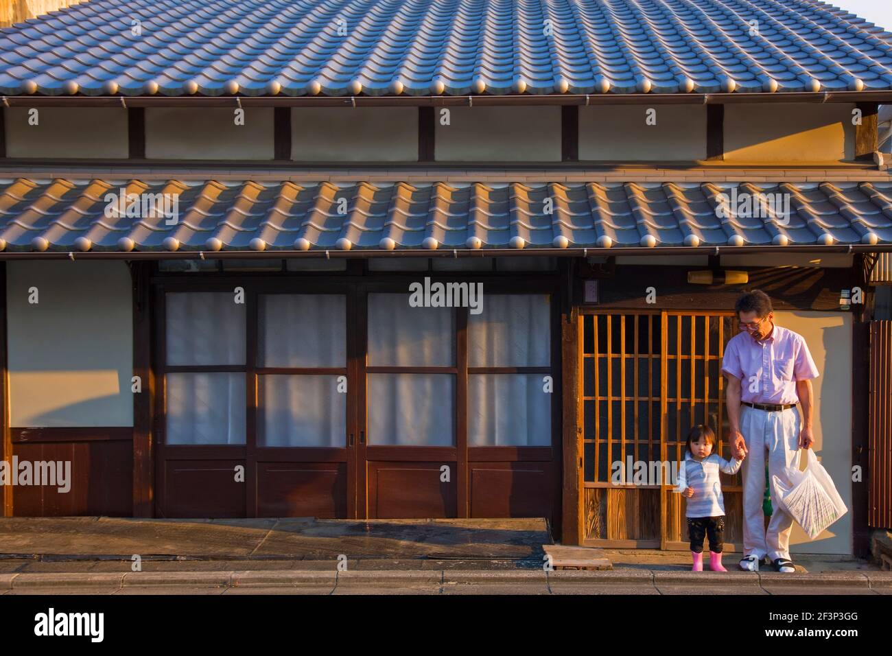 Late afternoon sunlight illuminates a traditional wood-and-plaster ...