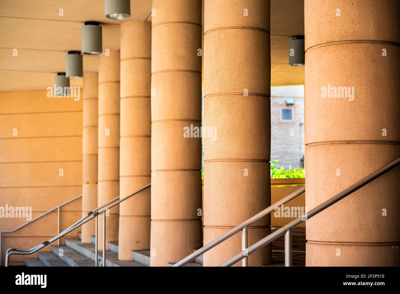 Abstract architectural row of columns pattern with hanging modern lamps ...