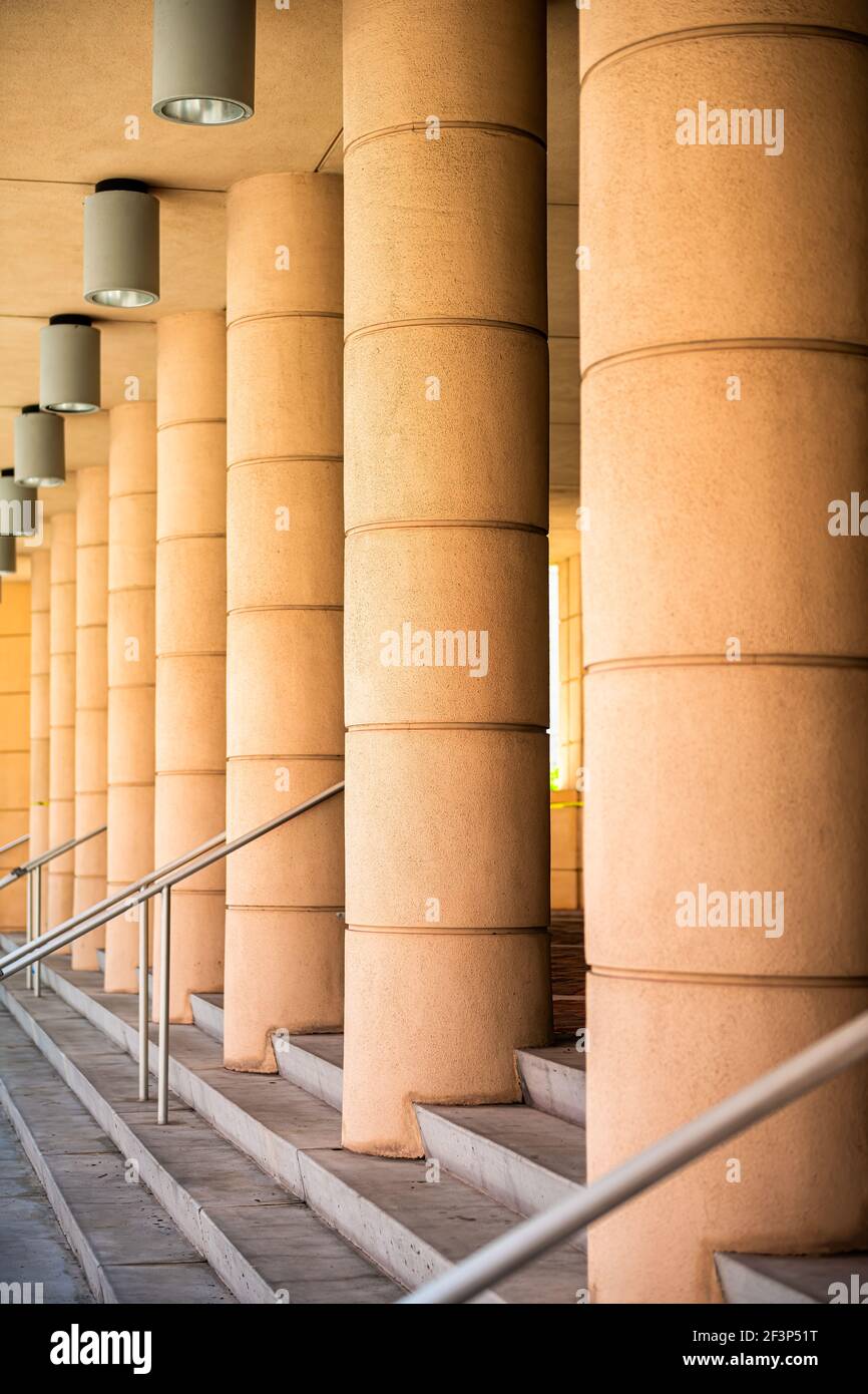 Abstract architectural row of columns pattern with hanging modern lamps ...