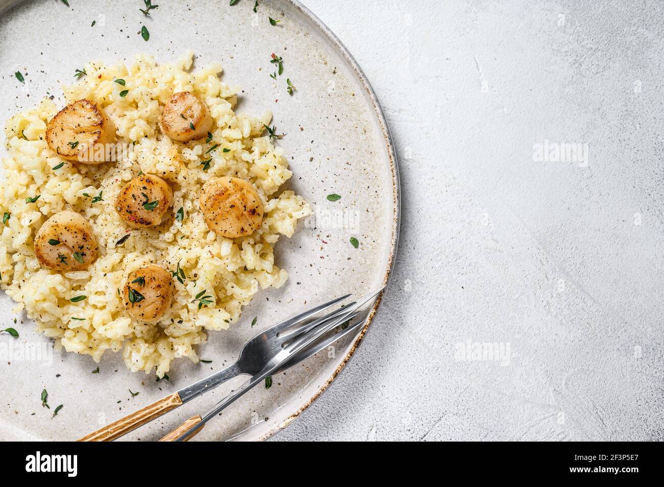 Italian Risotto with pan seared sea scallops. White background. Top ...