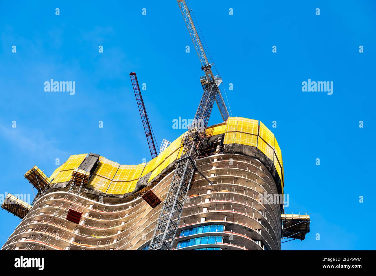Construction site with cranes building tower skyscraper structure ...