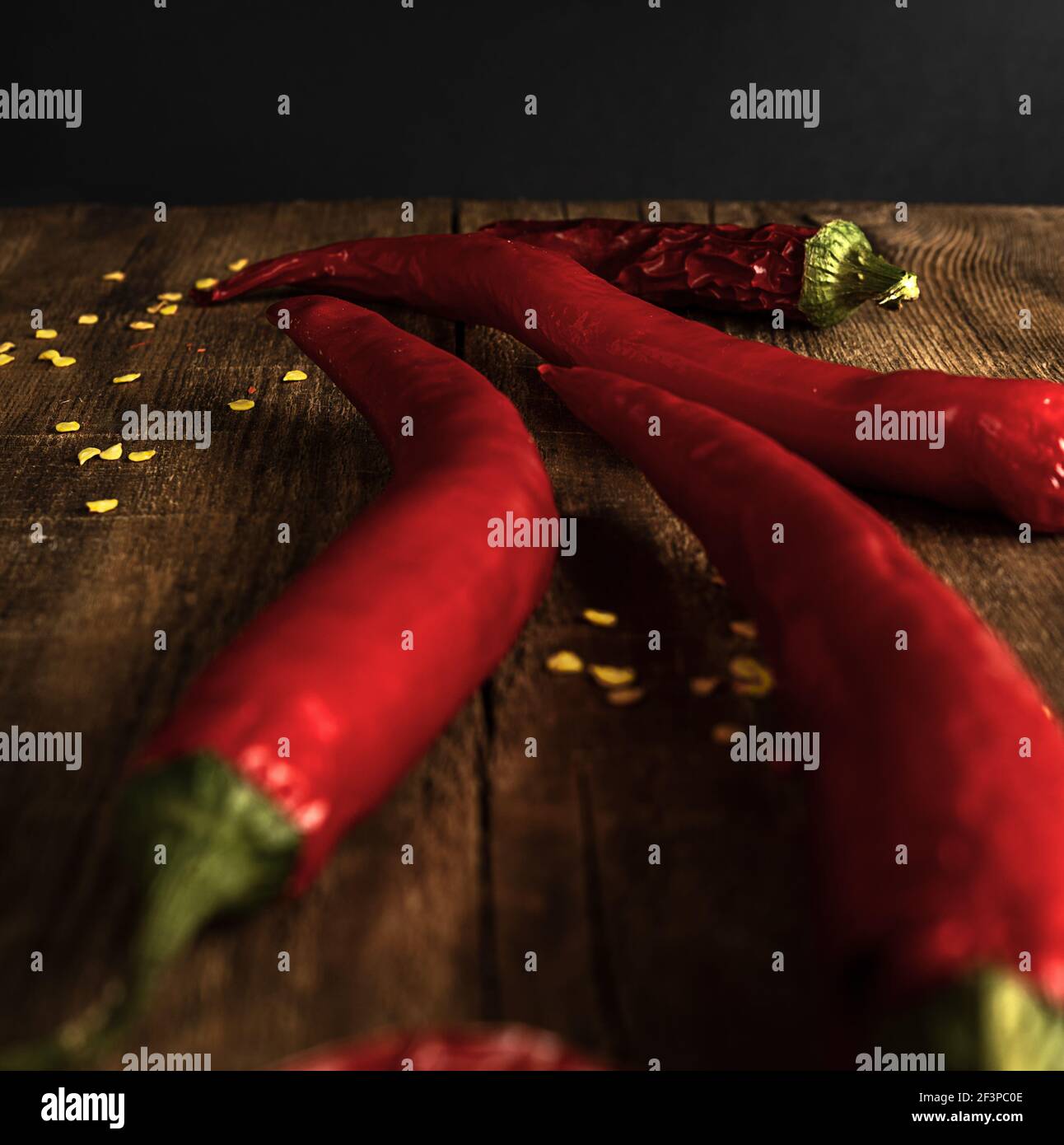 Dried red pepper pod in a low key on a wooden table. Rustic style Stock ...