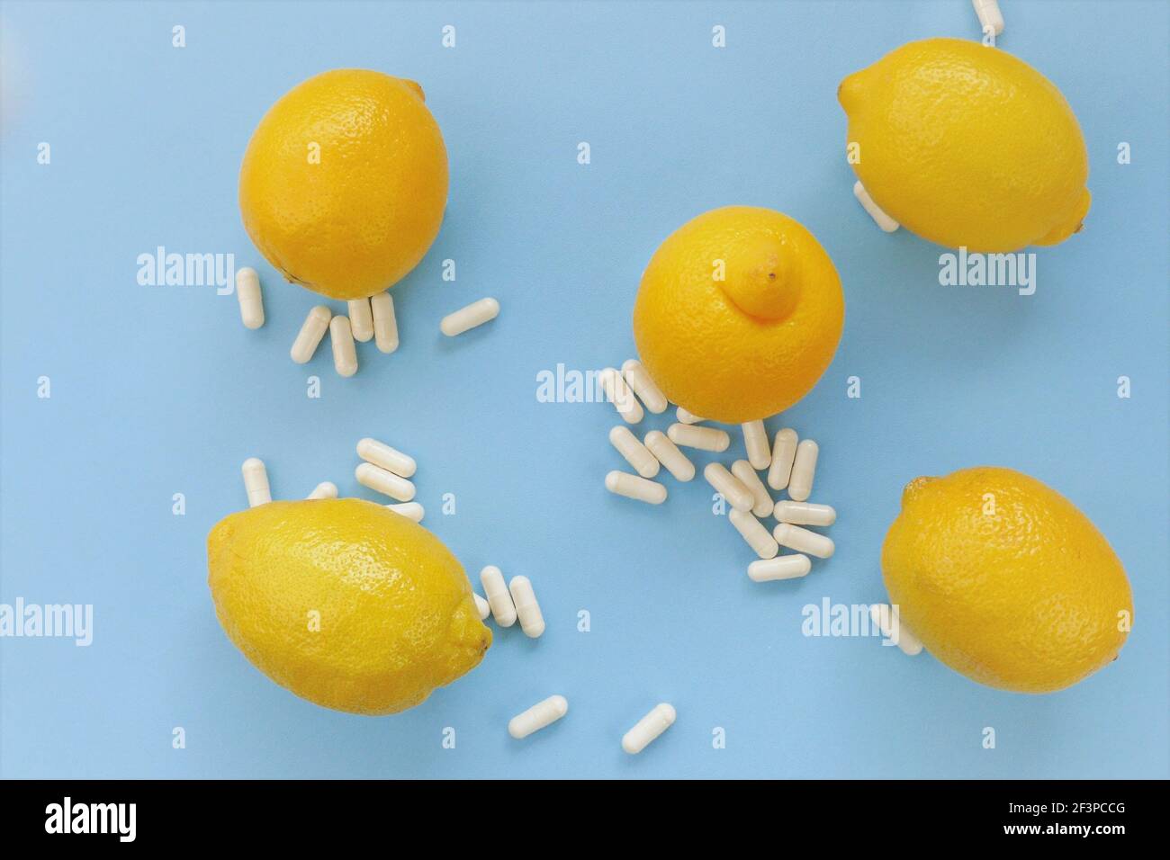 Vitamin C capsules.White capsules of vitamin, lemons set on a light ...