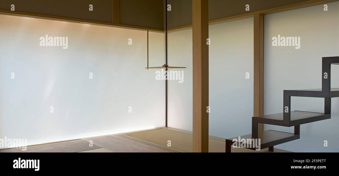 Traditionally Japanese sparsely furnished room with staircase Stock ...