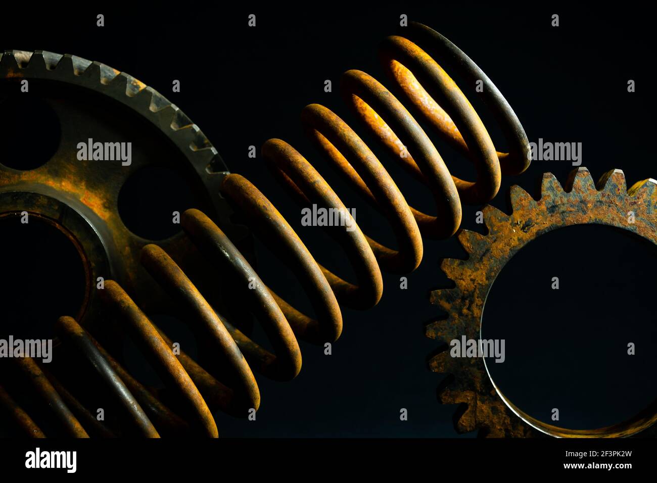 Rusted spring and gears with black background Stock Photo - Alamy