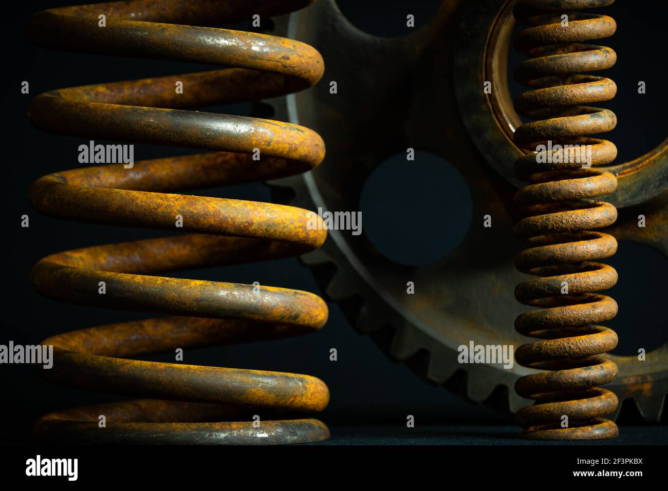 Rusted spring and gears with black background Stock Photo - Alamy