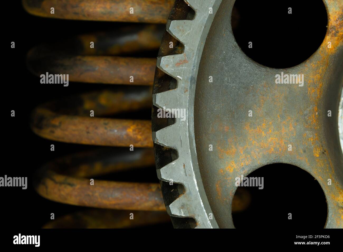Rusted spring and gears with black background Stock Photo - Alamy