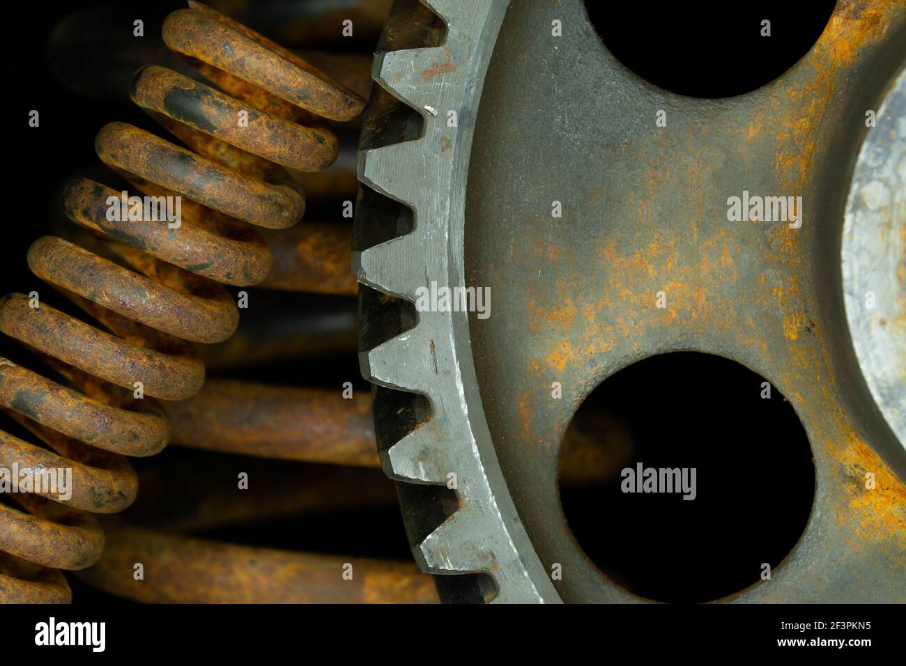 Rusted spring and gears with black background Stock Photo - Alamy