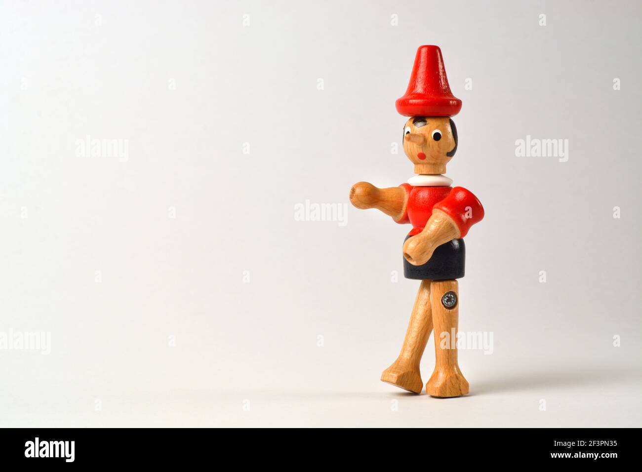 Wooden puppet depicting Pinocchio walking on a white background Stock ...