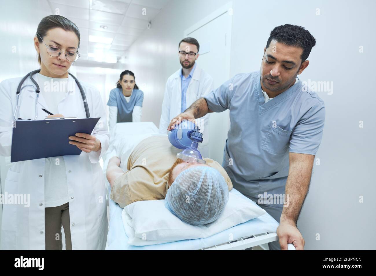 Team of doctors saving patient on the bed they performing a reanimation ...