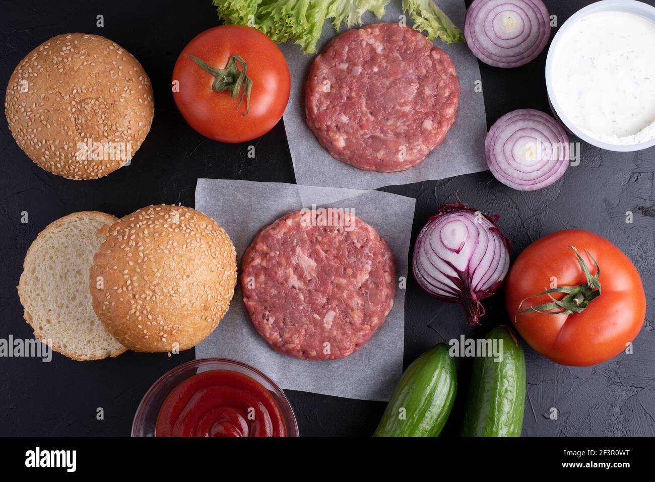 Ingredients for beef burger: raw beef patties, onion, lettuce, tomato ...