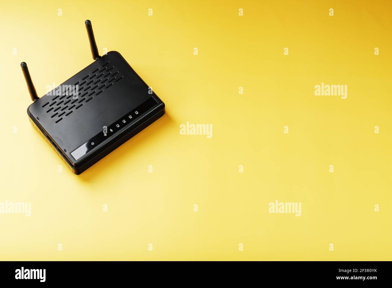 Wi-Fi router in black on a yellow background with free space. Internet ...