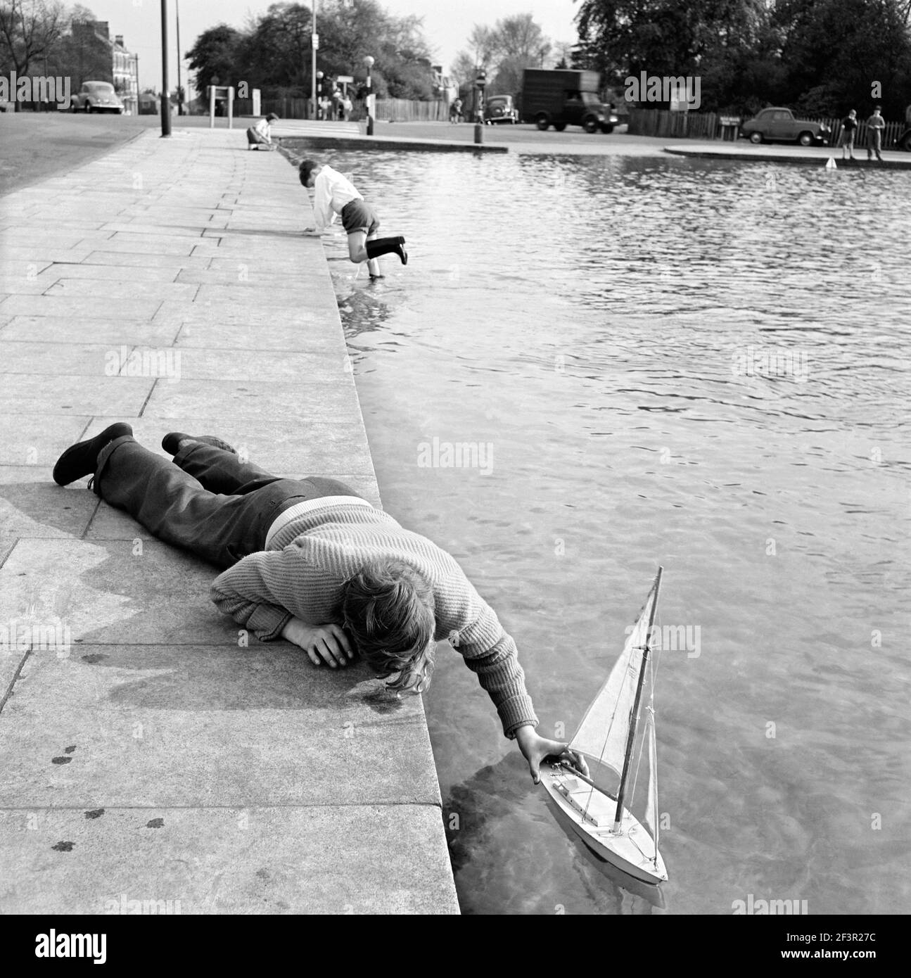 WHITESTONE POND, Hampstead Heath, London. View of a boy lying down on ...