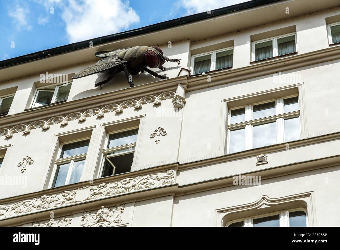 An insect sculpture on a white building Stock Photo - Alamy